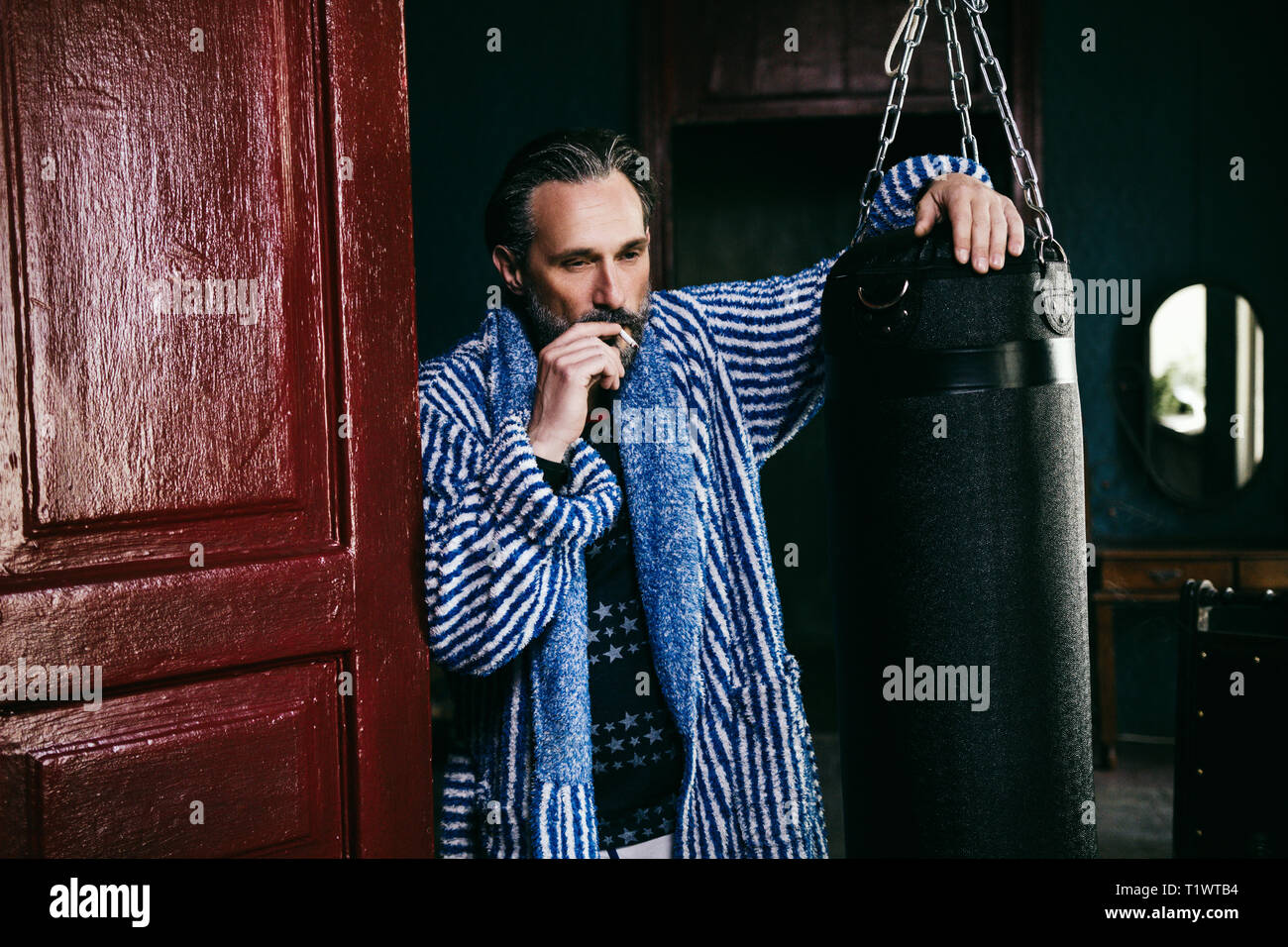 Man punching punch bag hi-res stock photography and images - Alamy