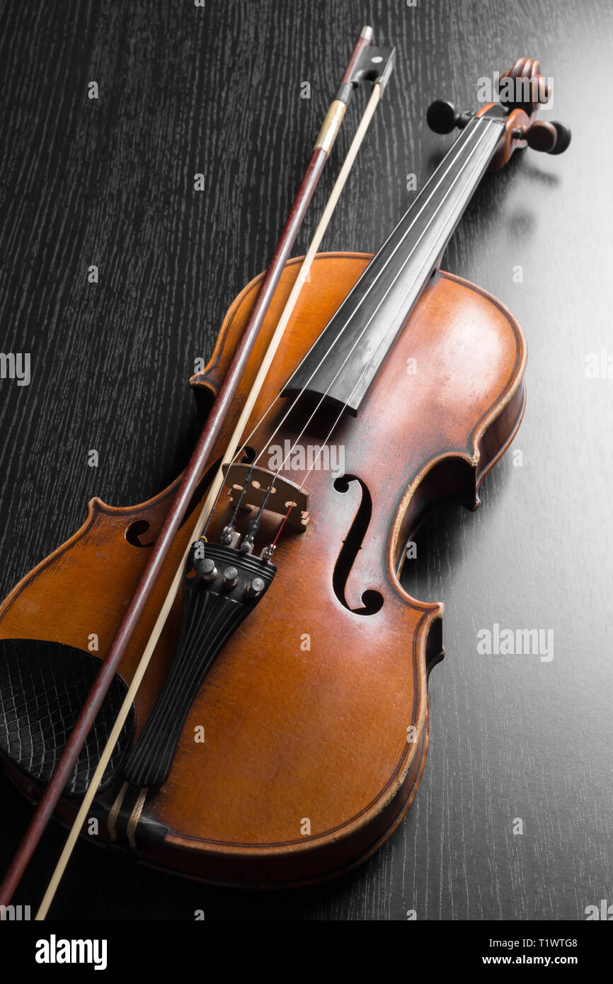 Old violin on a black background Stock Photo - Alamy