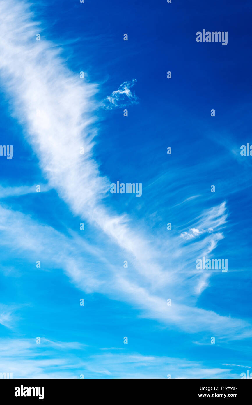 Unusual cloud formations against clear cobalt blue sky; central ...