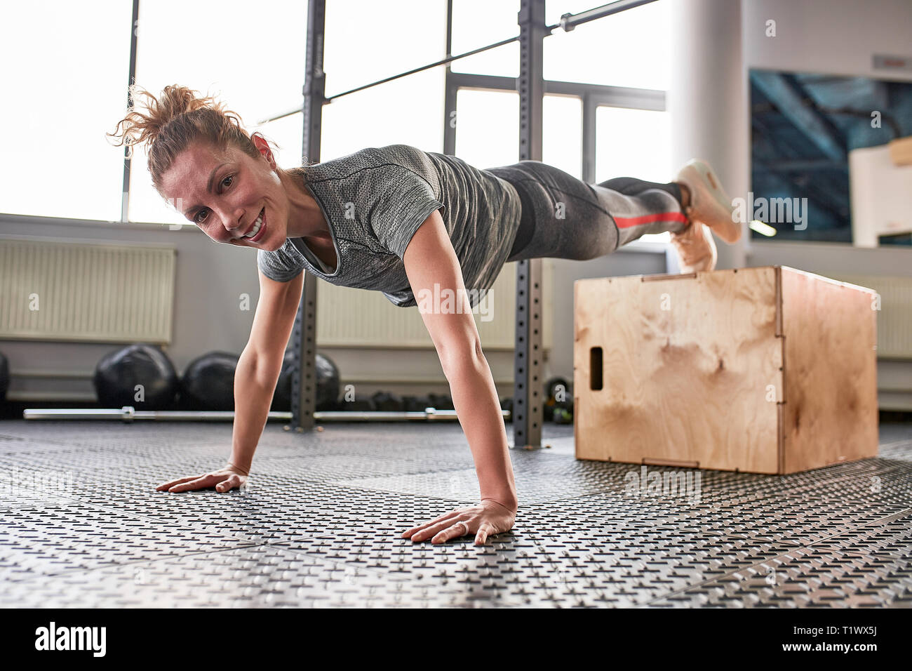 Athletic attractive woman wrung out in gym. Training concept, sport ...