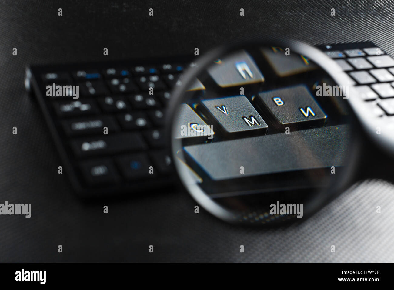 Magnifying Glass on black keyboard Stock Photo - Alamy