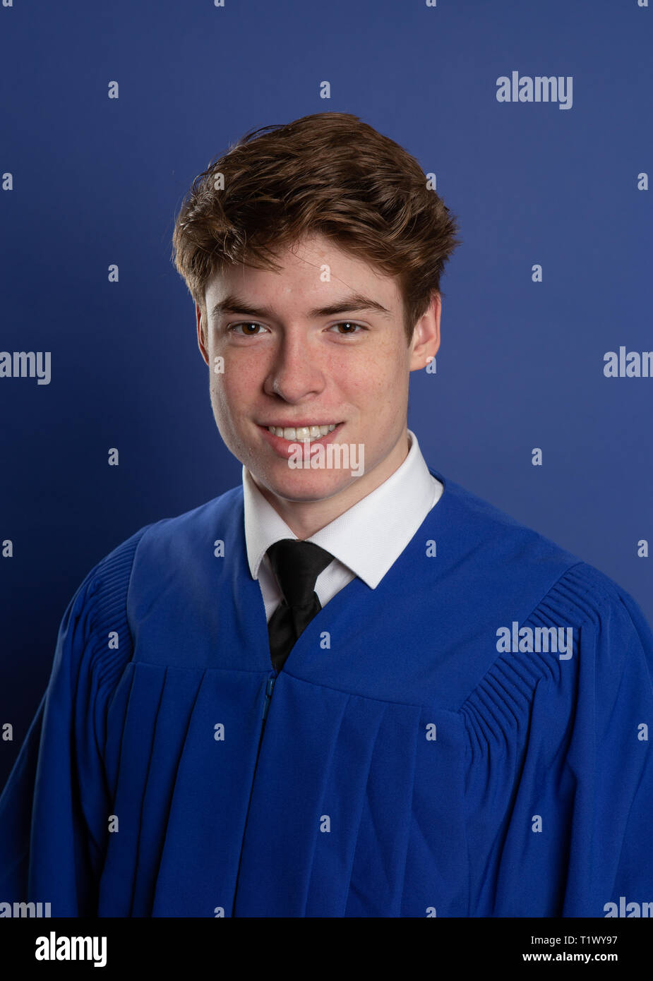 Graduation photo of young man in blue gown Stock Photo - Alamy