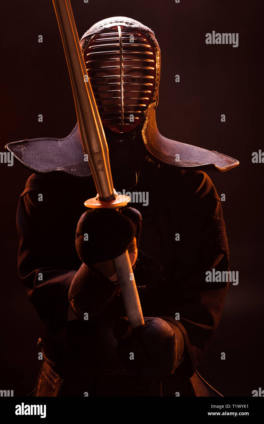 Kendo fighter in armor holding bamboo sword in smoke Stock Photo - Alamy