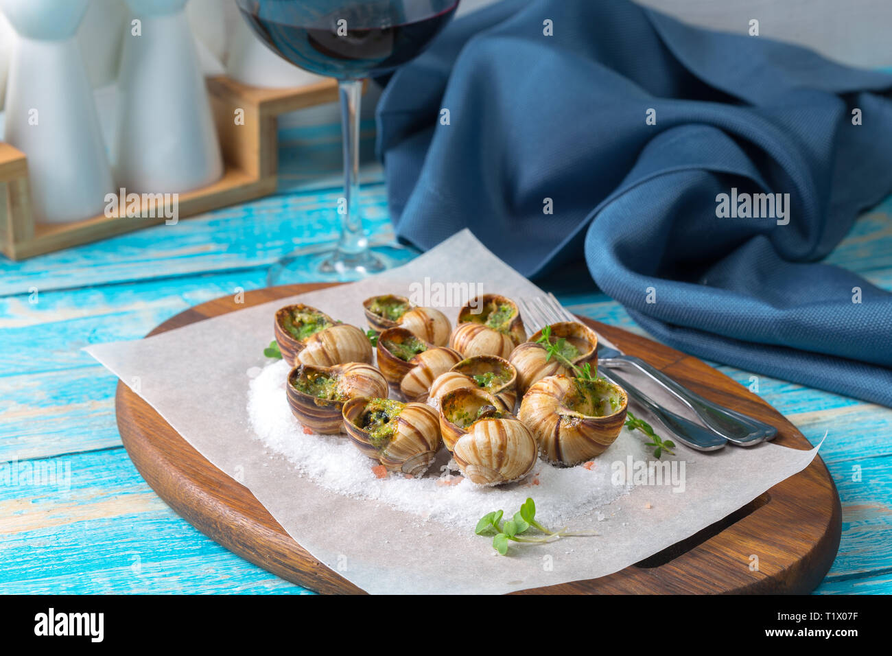 Baked snails with garlic butter and fresh herbs Stock Photo - Alamy