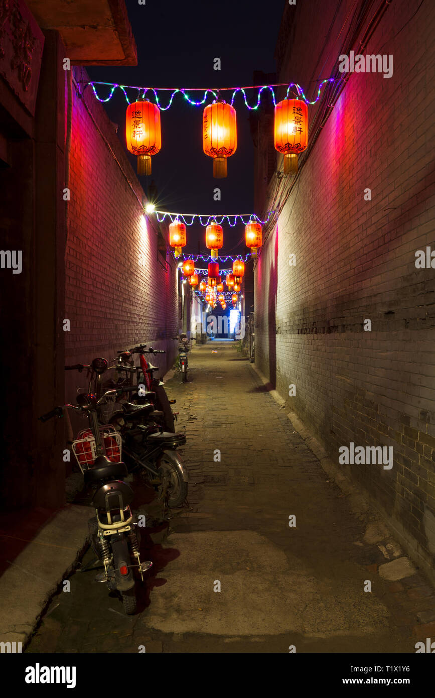 Red lanterns and bokeh at night in a street in Pingyao. The ancient ...