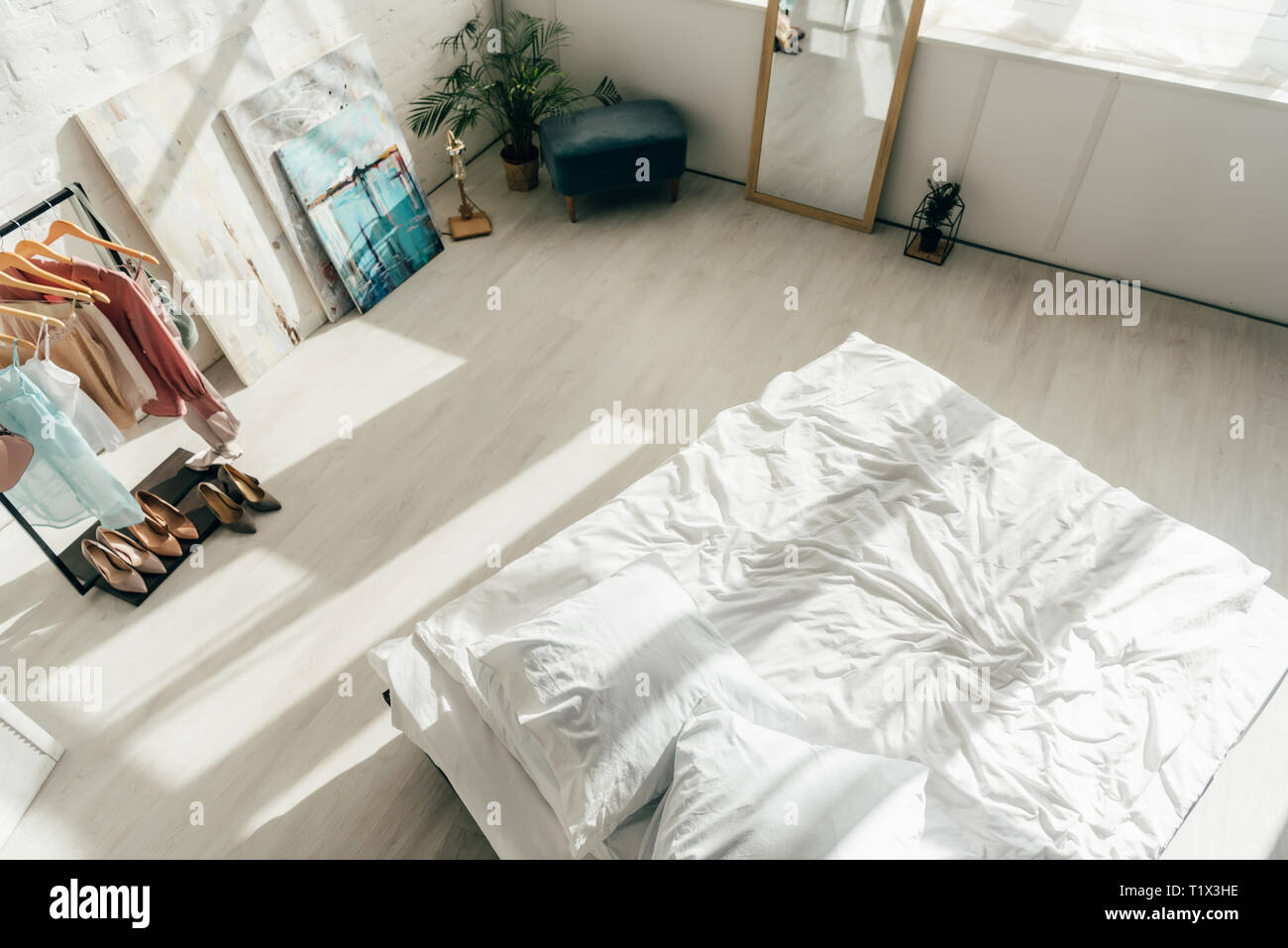 overhead view of modern white bedroom with bed and stylish wardrobe ...