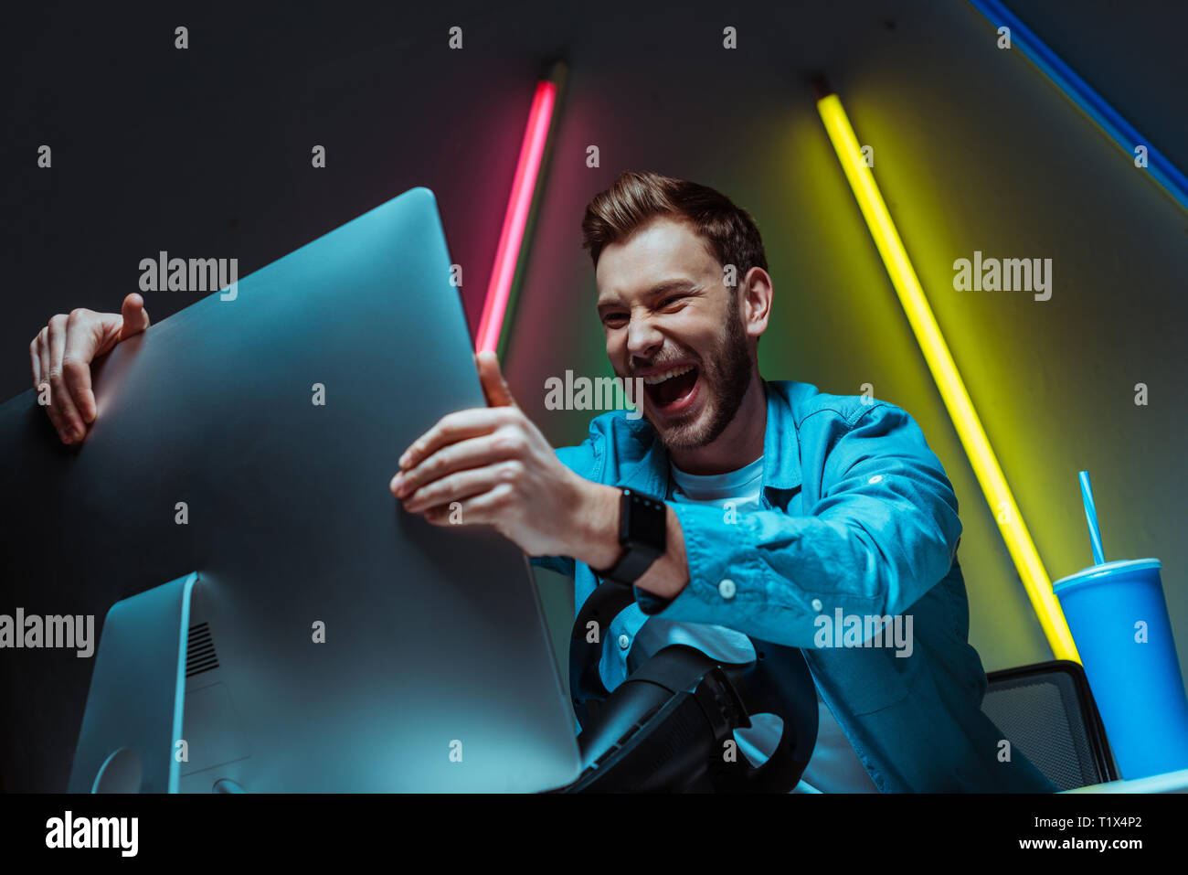 handsome and happy man smiling and holding computer monitor Stock Photo ...