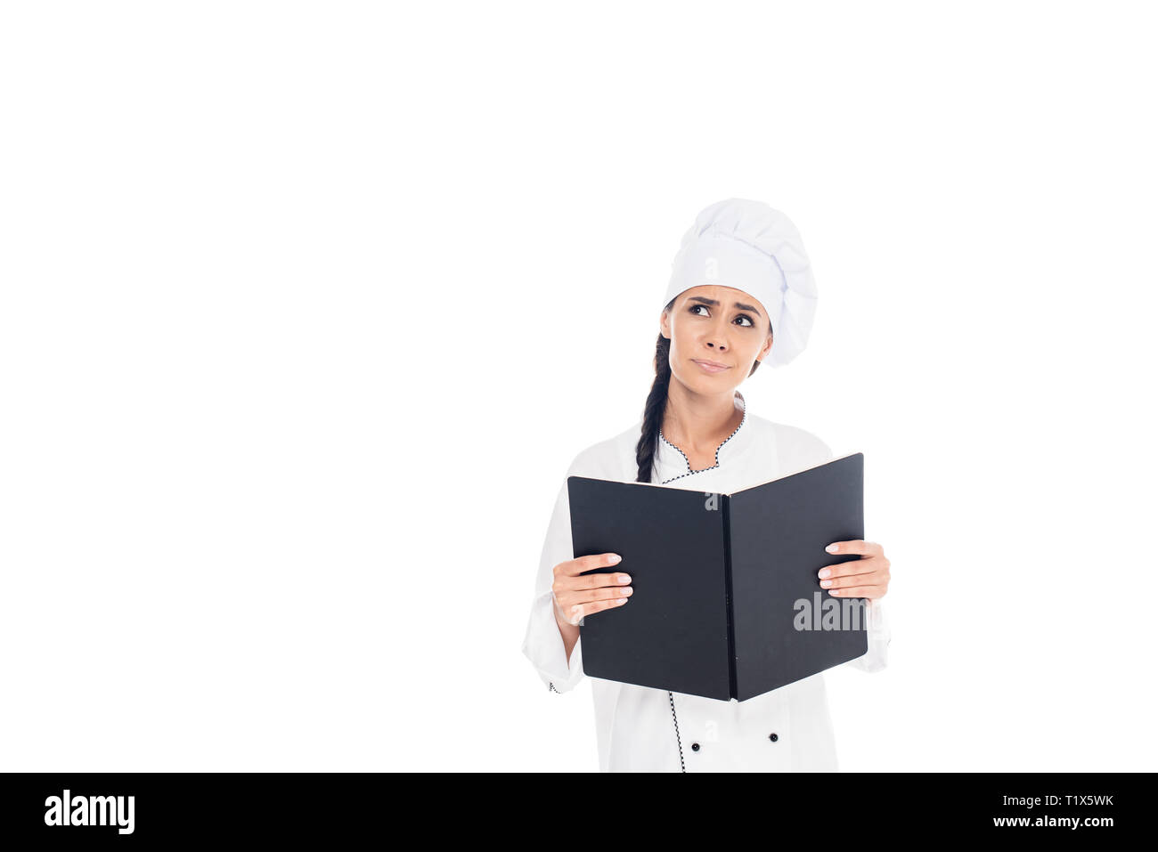 Sad chef in uniform holding black book isolated on white Stock Photo ...