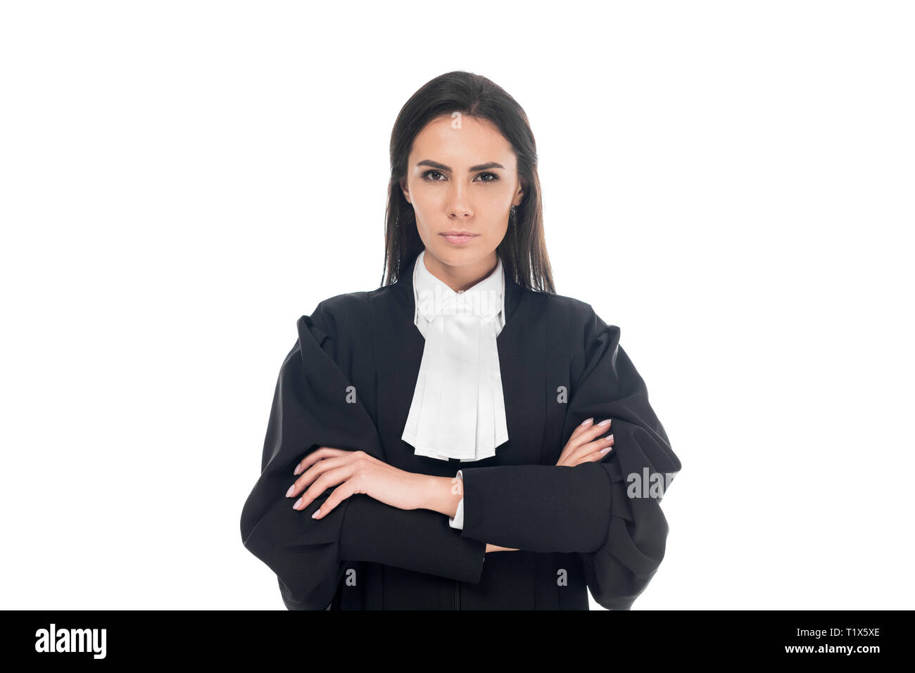 Front view of serious judge in judicial robe standing with folded arms ...
