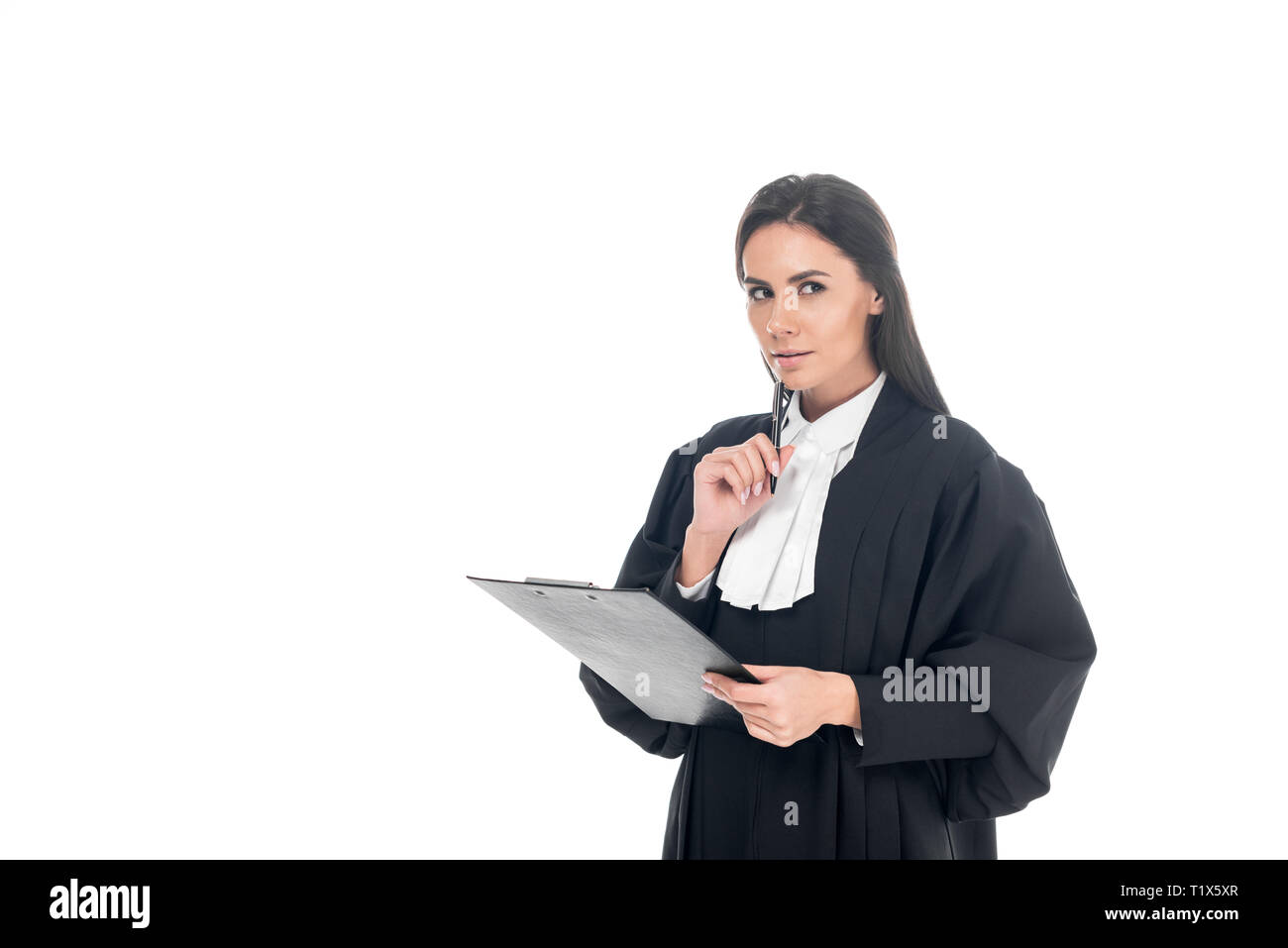 Pensive judge in judicial robe holding clipboard and pen isolated on ...