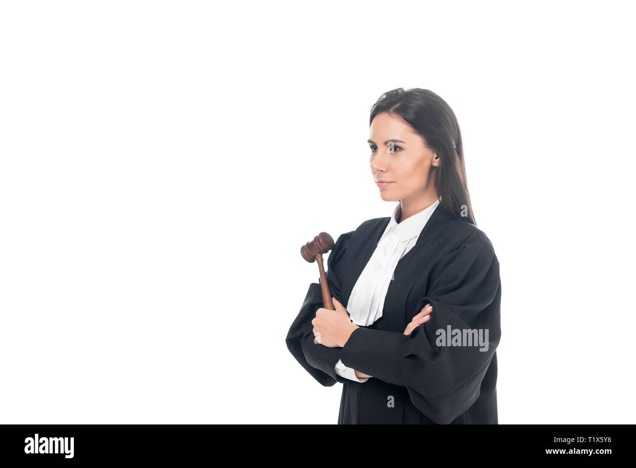 Judge in judicial robe holding gavel and standing with folded arms ...
