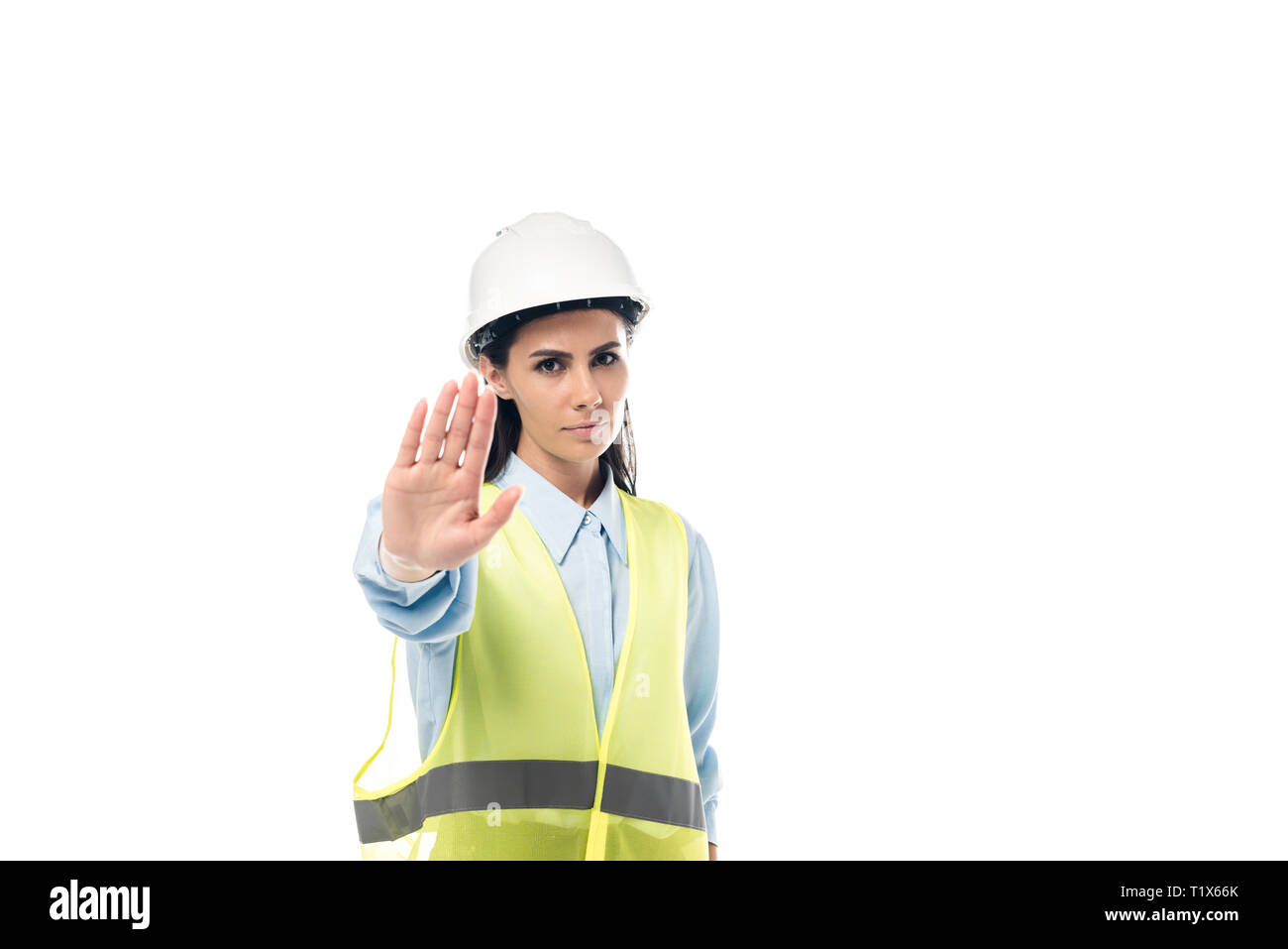 Strict engineer in hardhat showing stop sign isolated on white Stock ...
