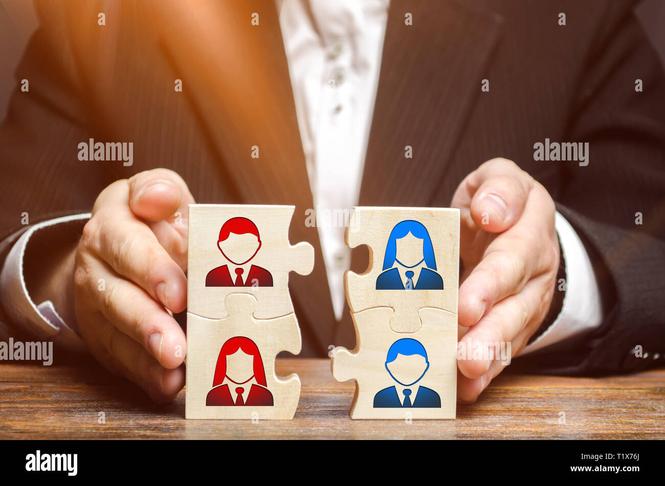 Businessman collects puzzles symbolizing the team of employees ...