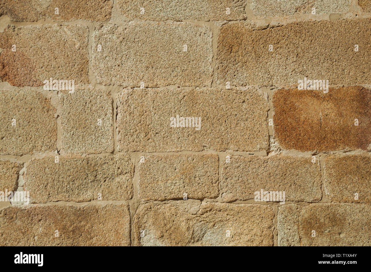 Wall made of large stone bricks forming a charming background in ...