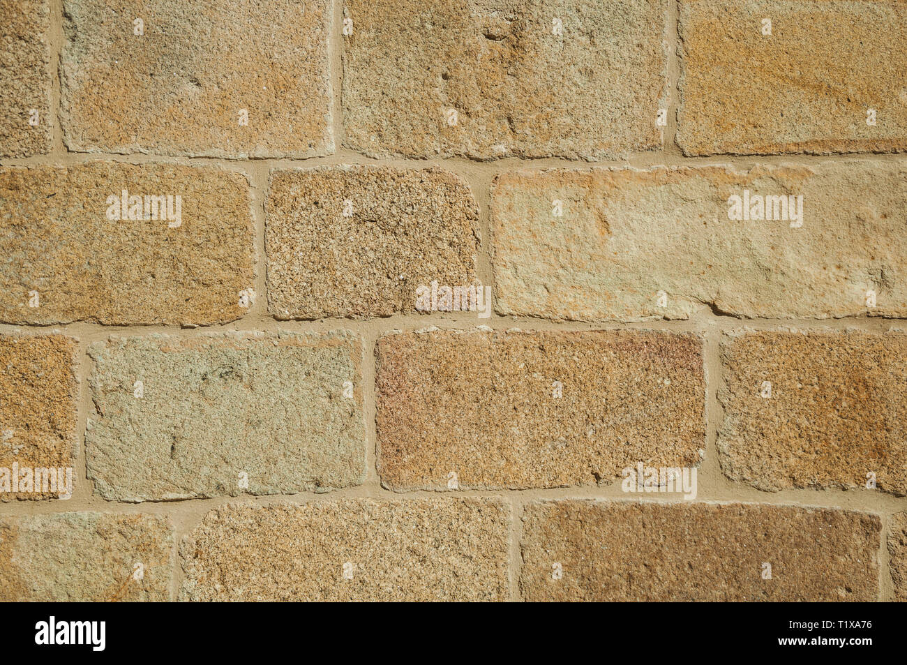 Wall made of large stone bricks forming a charming background in ...