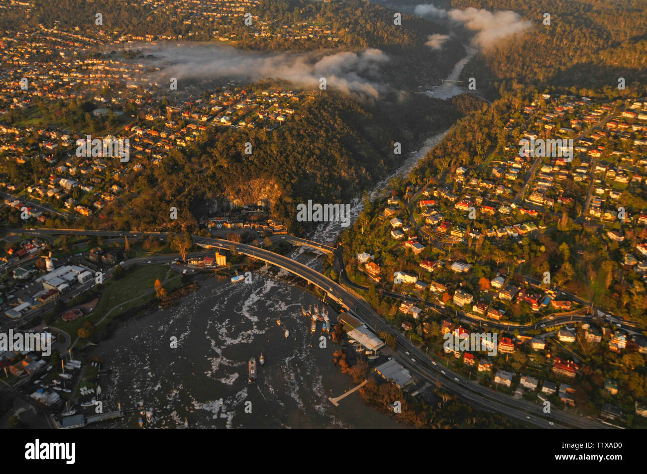 Aerial image of orange dawn sunlight shining through river ground-mist ...