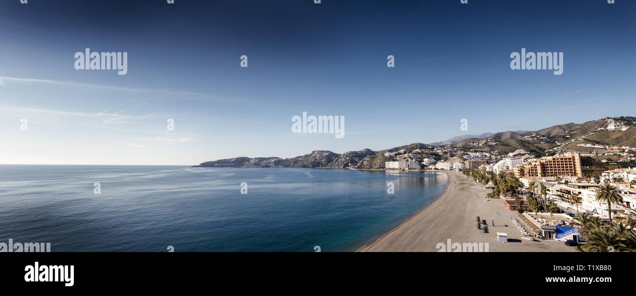 landscape image of the town almunecar in spain showing the beach and ...