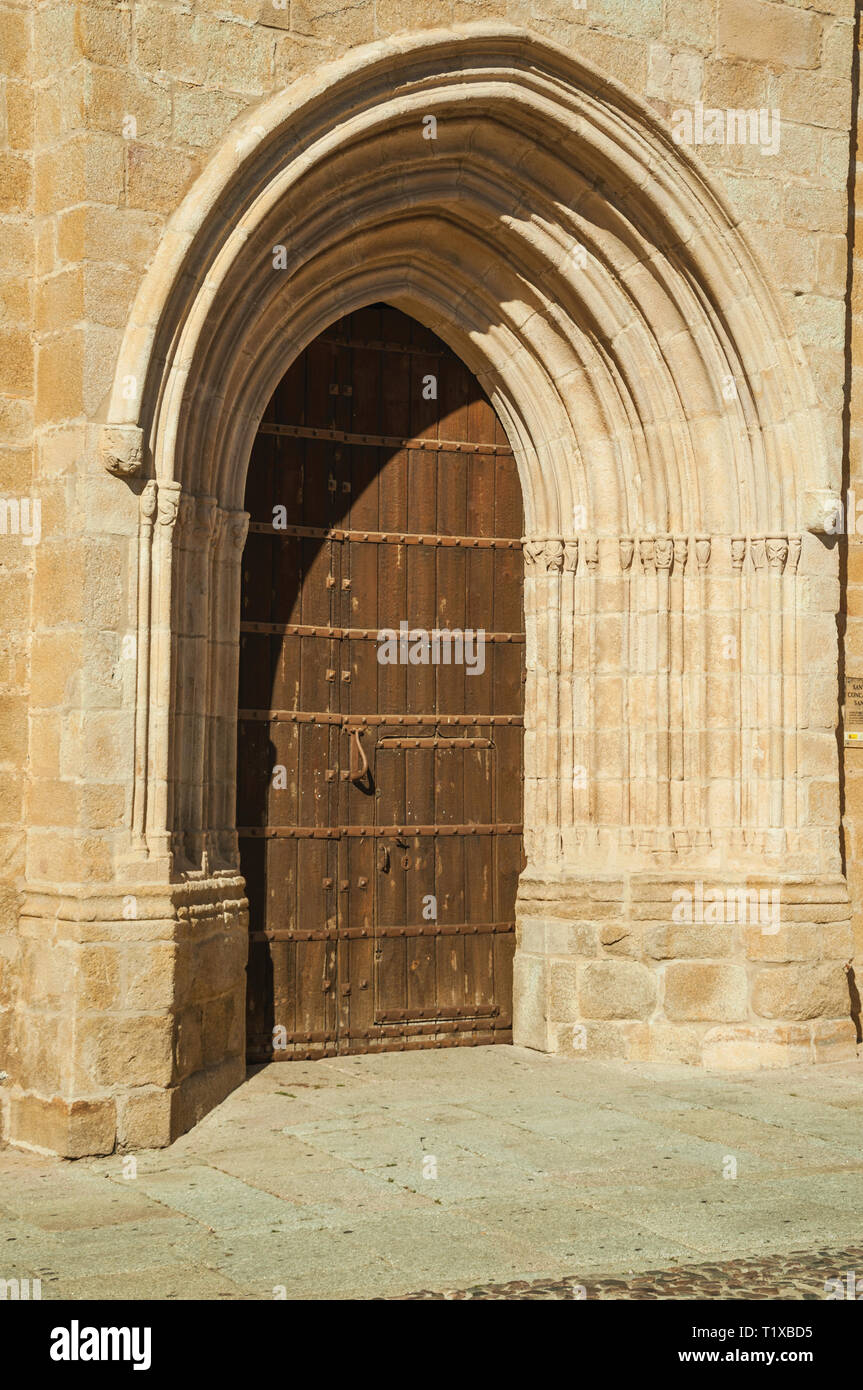 Big wooden door with labored medieval stone arches on Cathedral facade ...