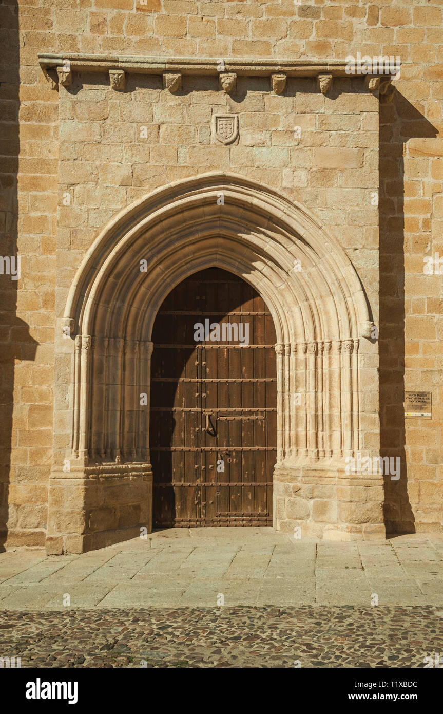 Big wooden door with labored medieval stone arches on Cathedral facade ...