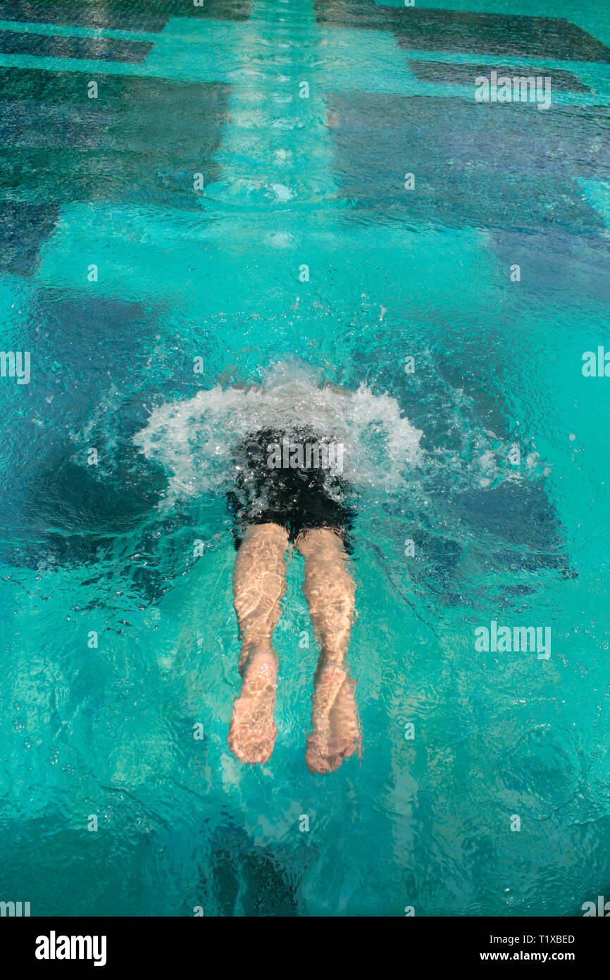 Man diving into swimming pool hi-res stock photography and images - Alamy