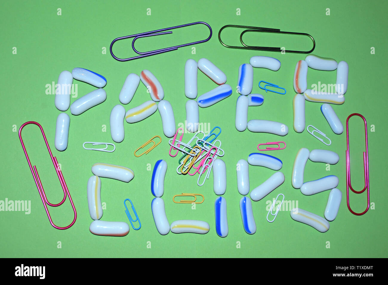 Paper clips on the table as background.Bunch of color paperclips on a ...