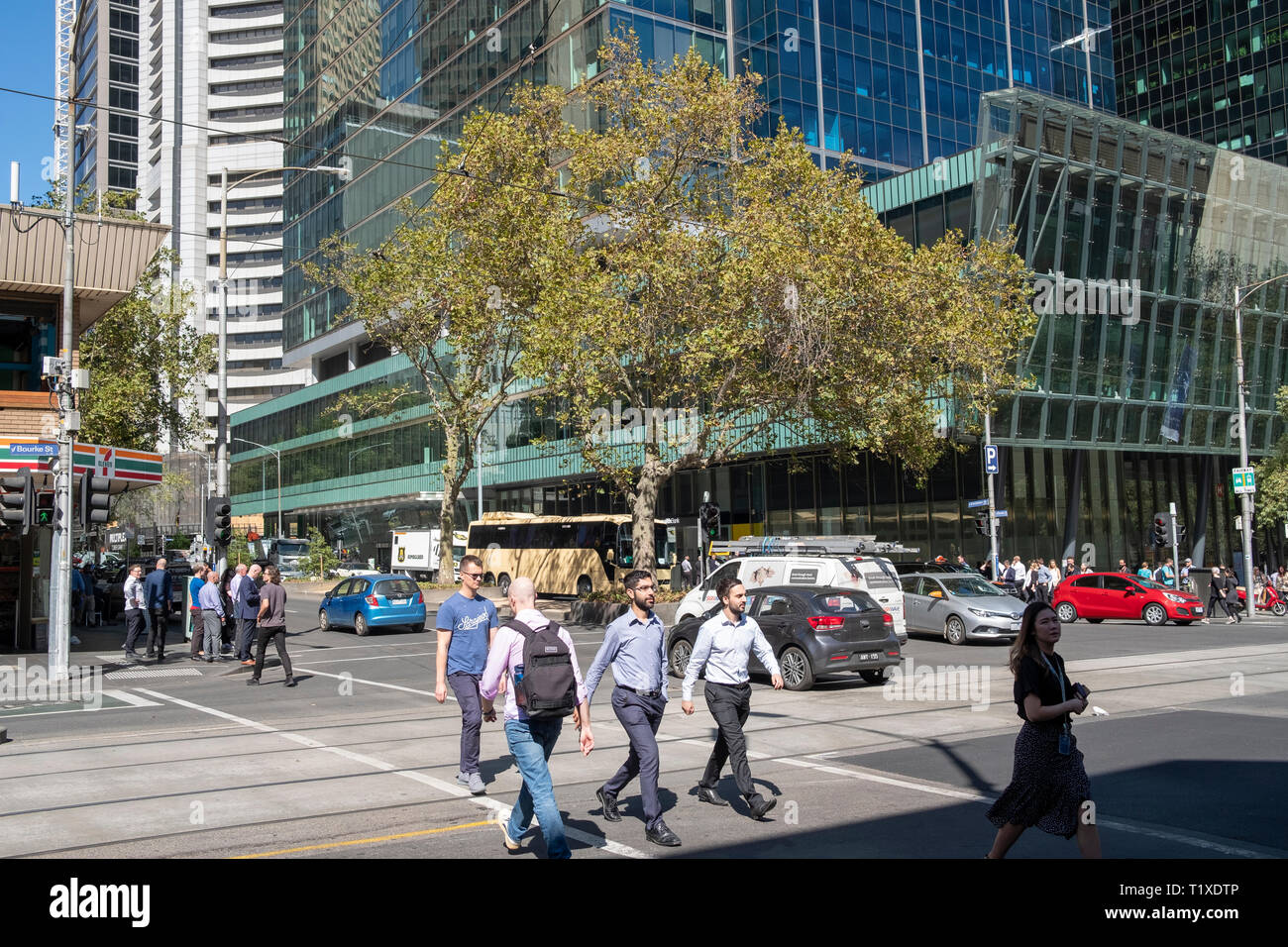 Melbourne city centre and people crossing the road past corporate ...