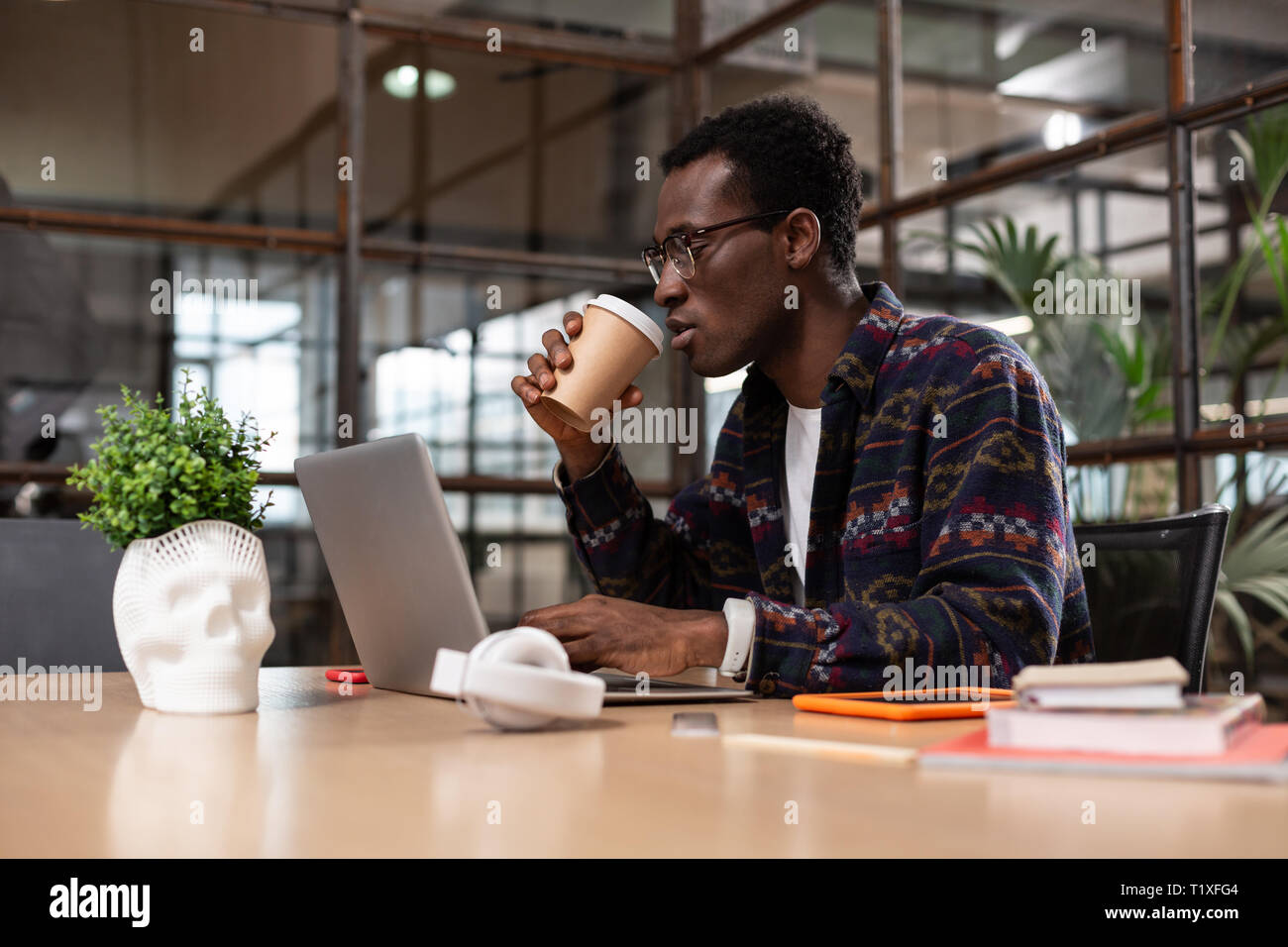 Man drinking coffee while working with the computer Stock Photo - Alamy