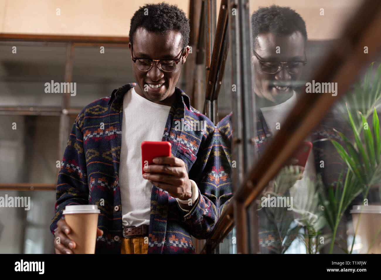 Smiling man concentrated on his texting conversation Stock Photo - Alamy