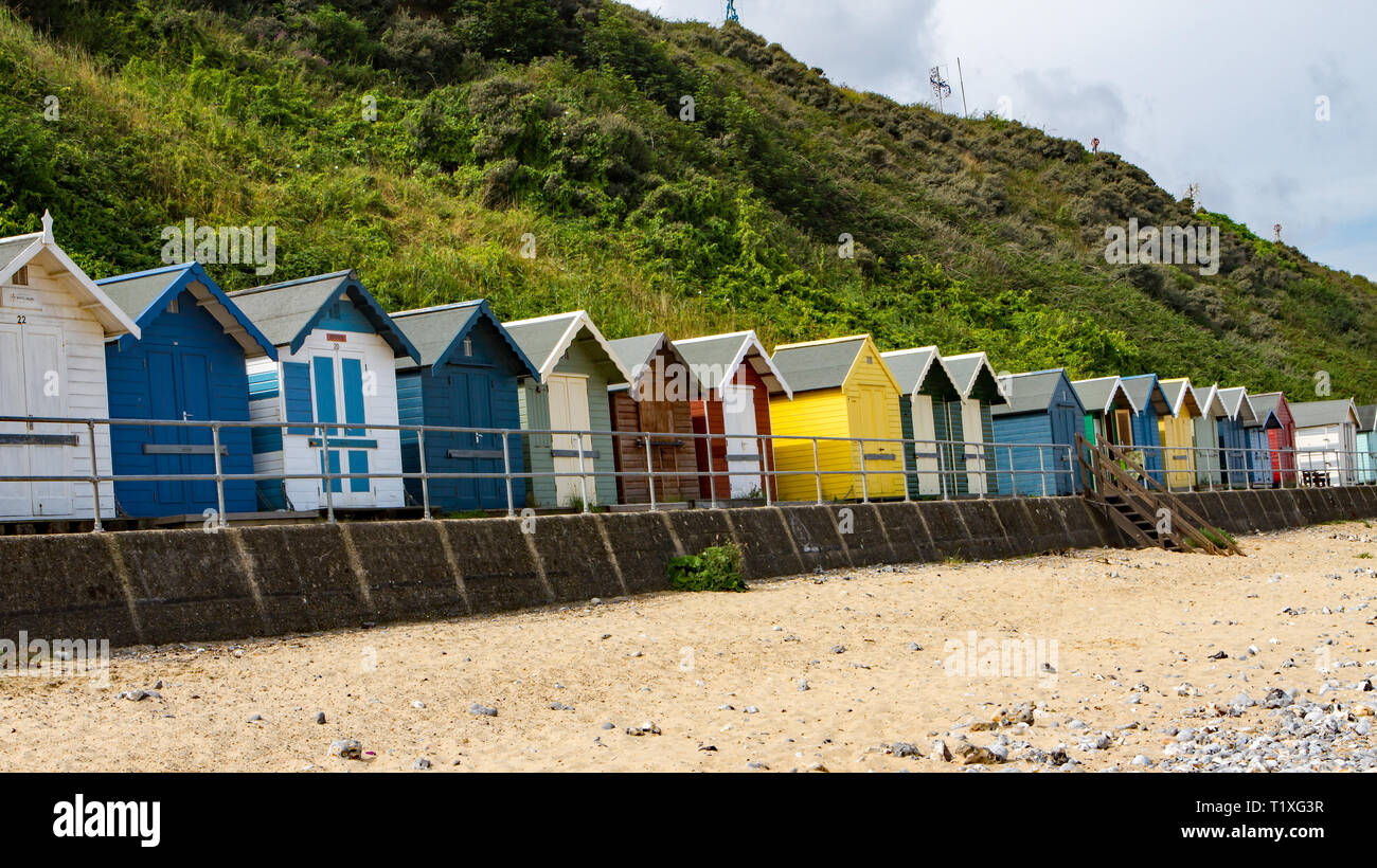 A row of colourful traditional wooden beach huts in Cromer locked up at ...