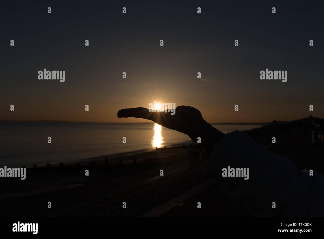 praying at sunset by ocean Stock Photo - Alamy