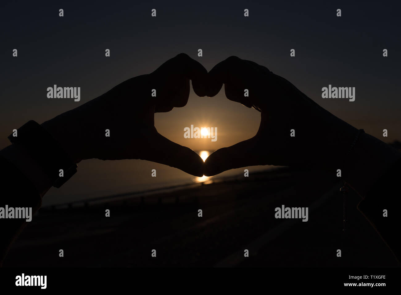 praying at sunset by ocean Stock Photo - Alamy