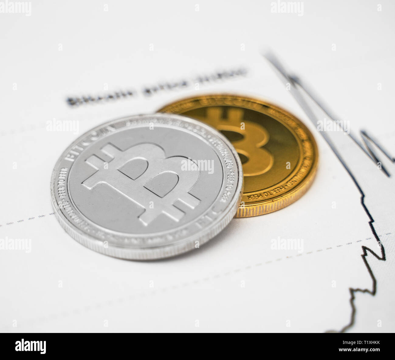Physical bitcoins and Bitcoin Price Index on the paper Stock Photo - Alamy