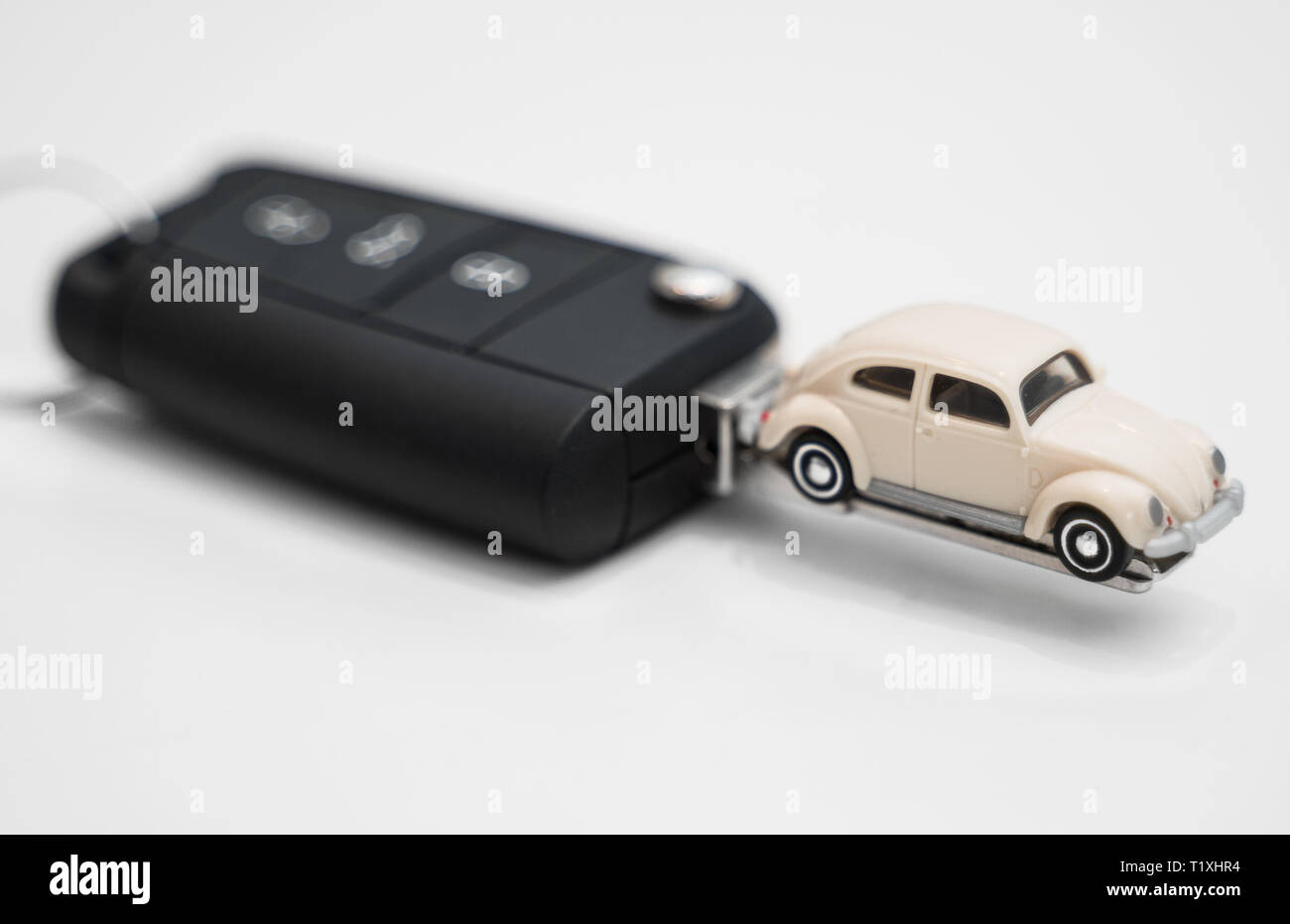 Car key with car toy on white background Stock Photo - Alamy