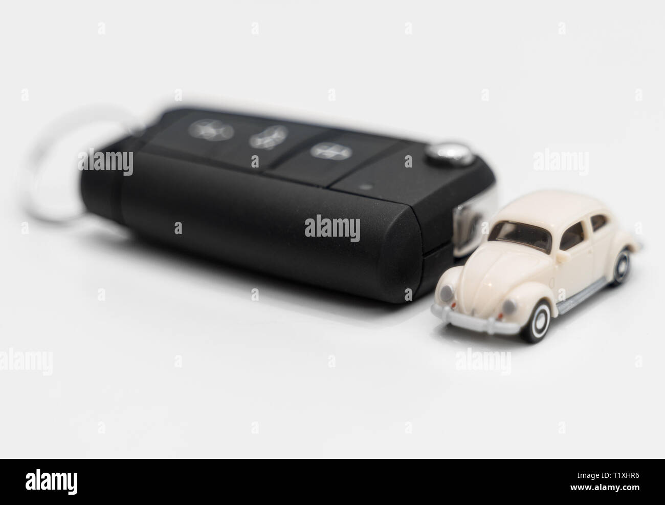 Car key with car toy on white background Stock Photo - Alamy
