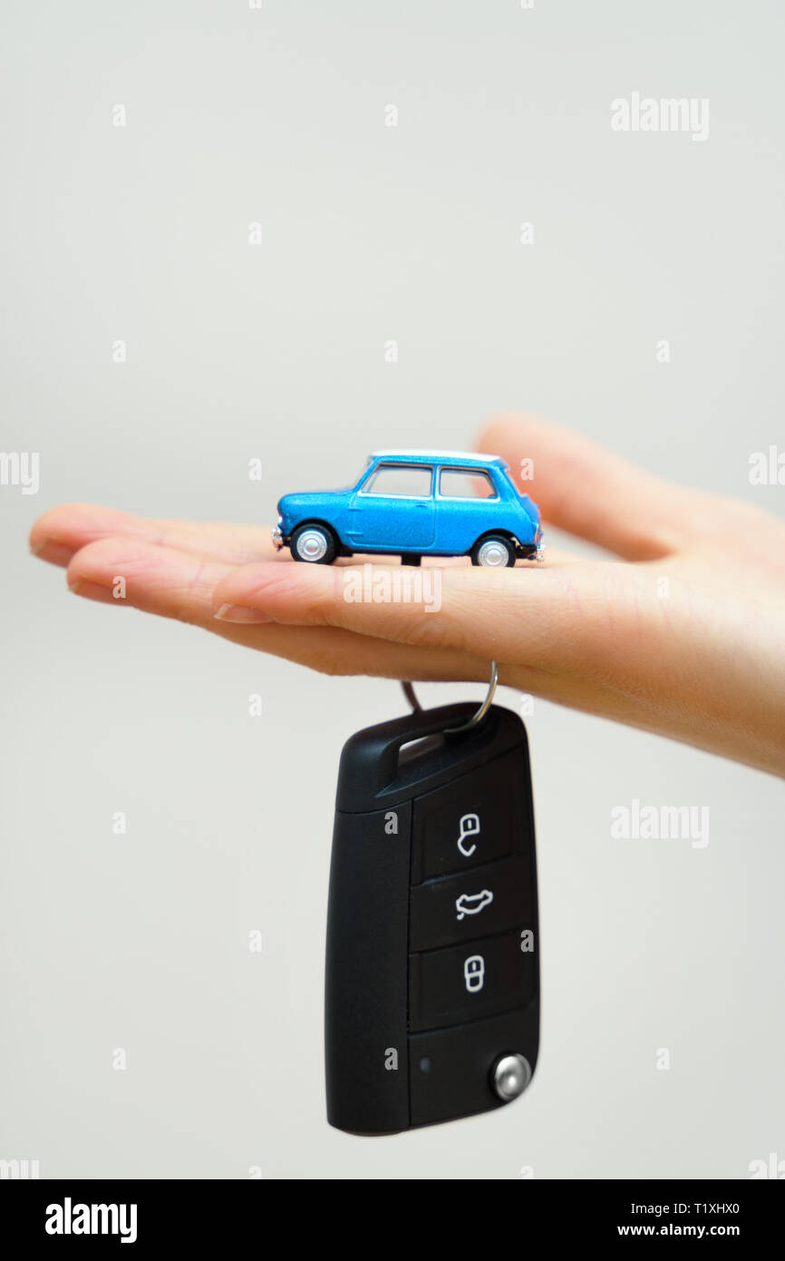 Hand holding small car toy and keys. Car purchase concept Stock Photo ...
