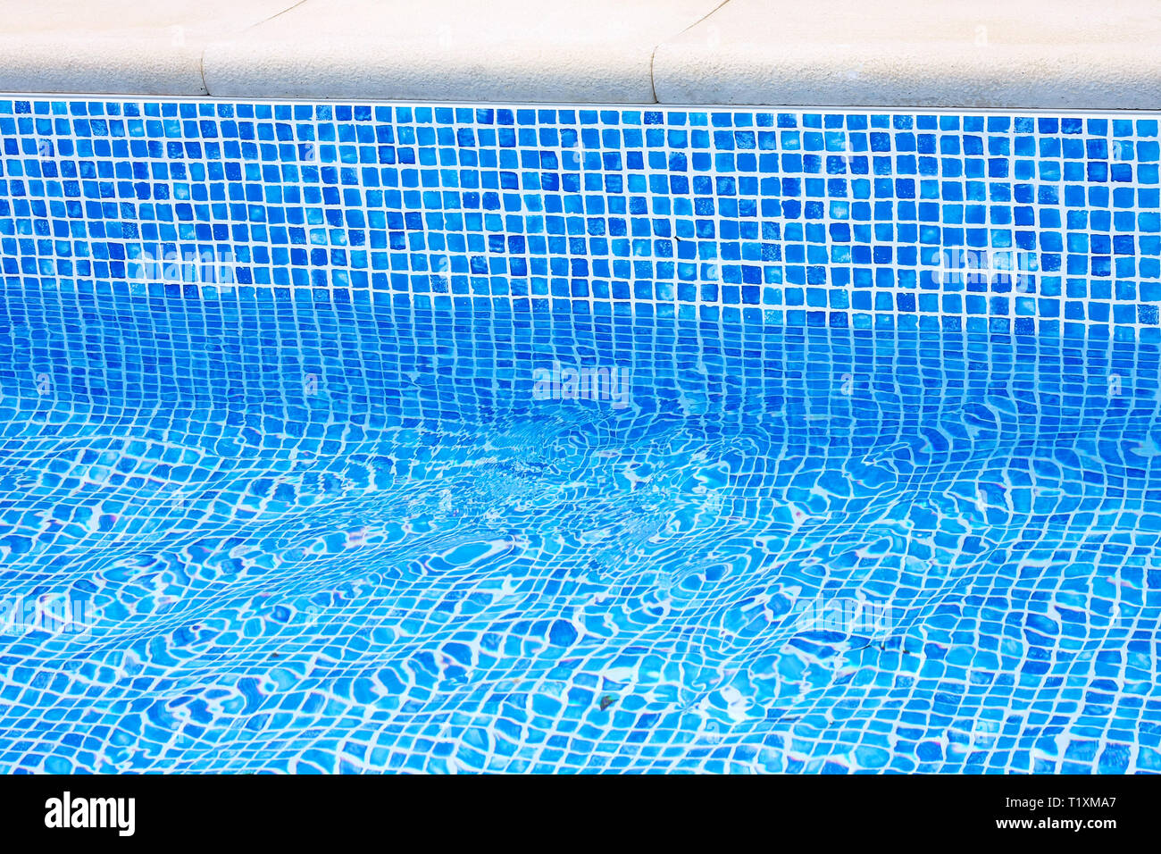 Mosaic blue tiles at swimming pool edge Stock Photo - Alamy