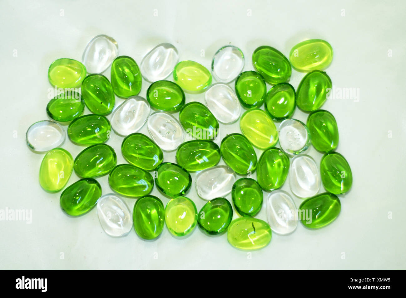 Bunch of green and transparent glass pebbles and stones Stock Photo - Alamy