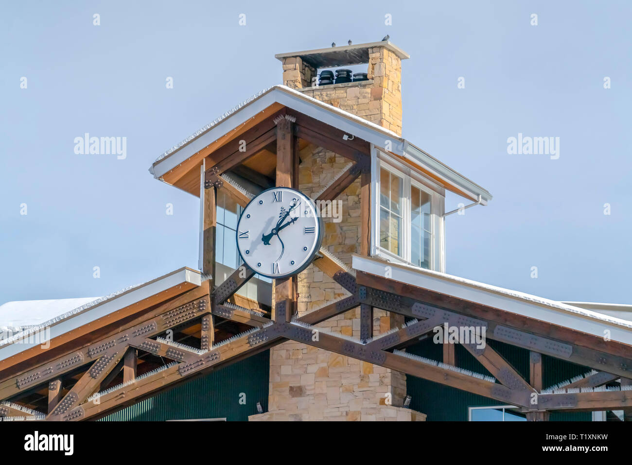 Building with a clock and snowy roof in Park City . Close up of the ...