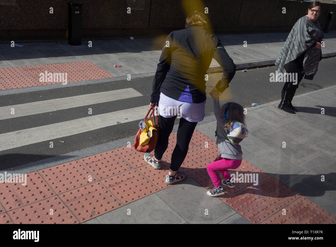A mother and her troublesome child at a bus stop in south London, on ...