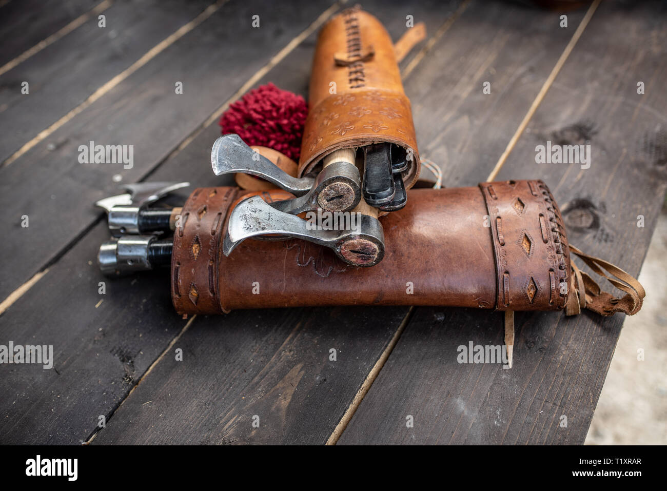 Set of three throwing axes in leather sheath Stock Photo - Alamy