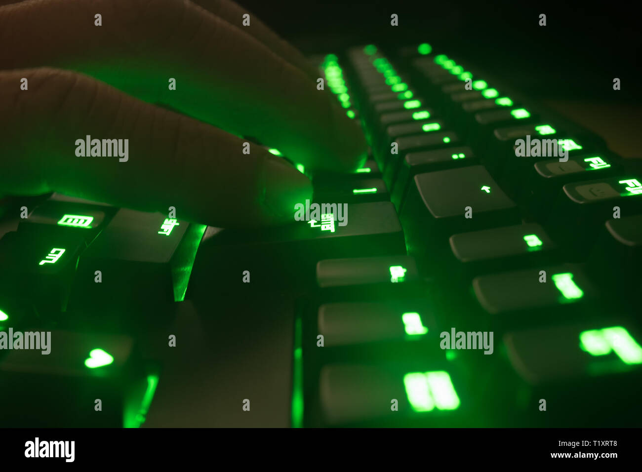 Man typing on green keyboard Stock Photo - Alamy