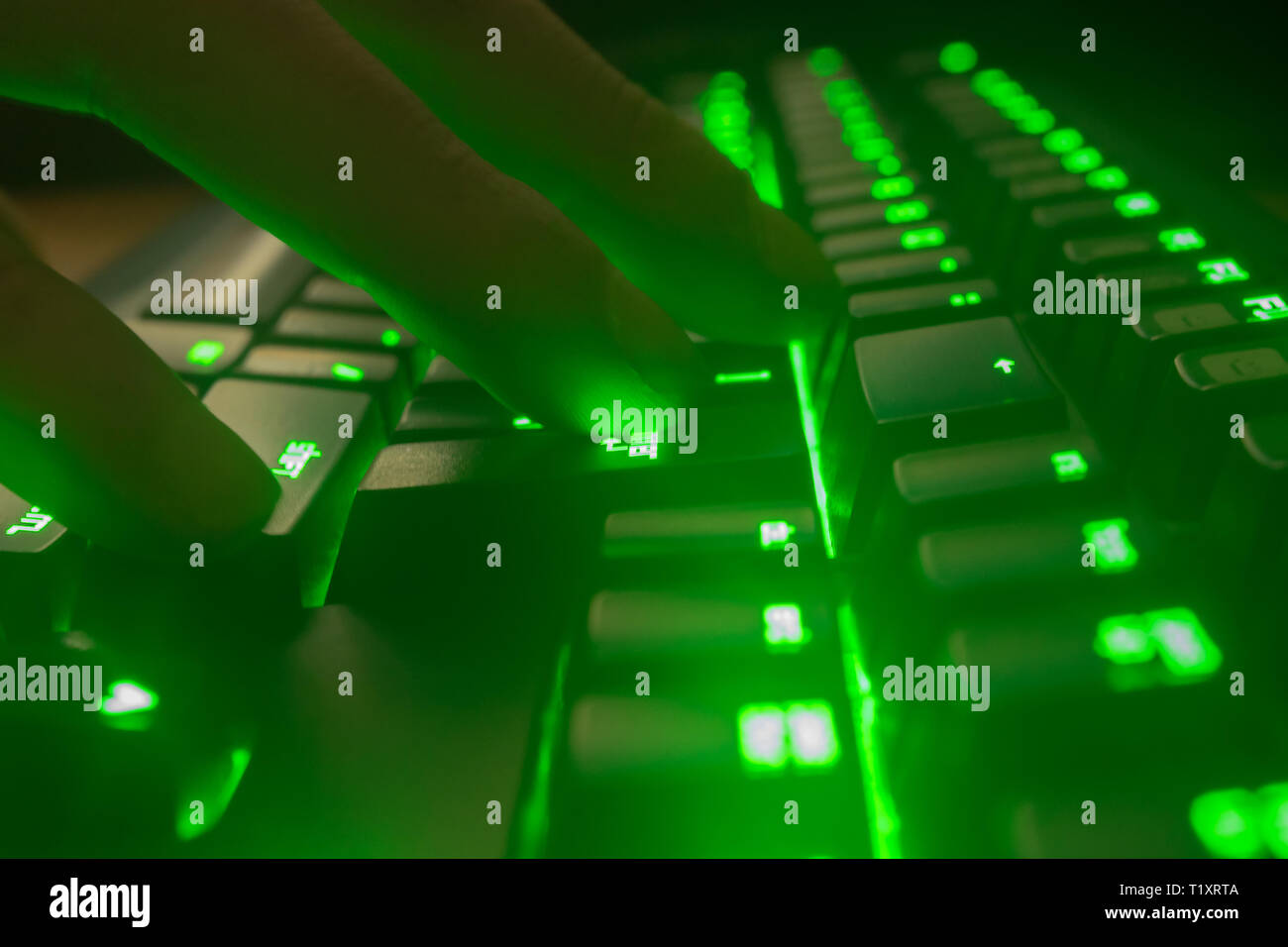 Typing on green keyboard. Concept of hacking Stock Photo - Alamy