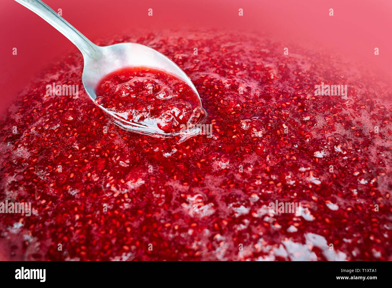 Raspberry jam on the spoon Stock Photo - Alamy