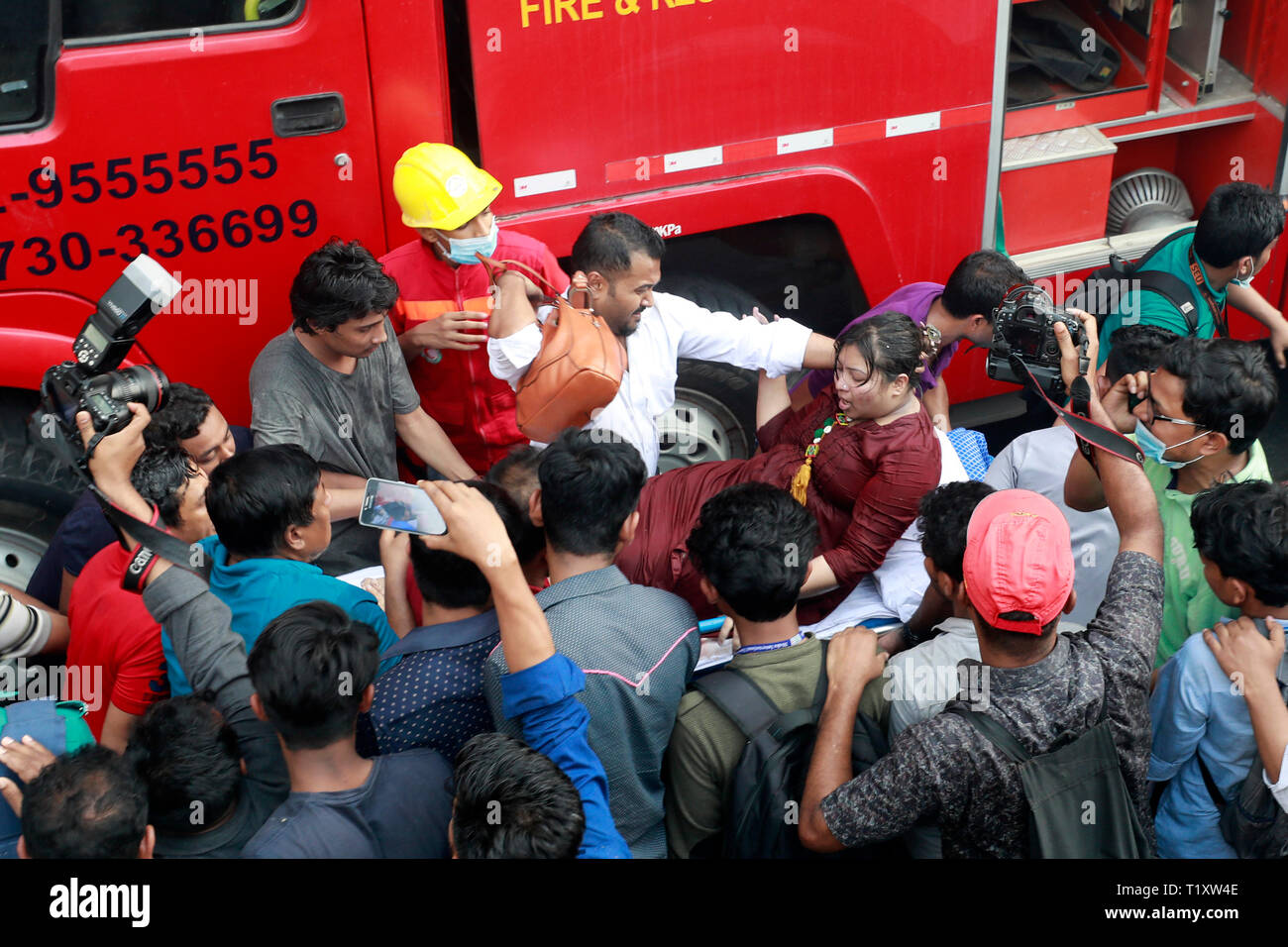 Dhaka, Bangladesh - March, 28, 2019: Rescuers carrying people injured ...