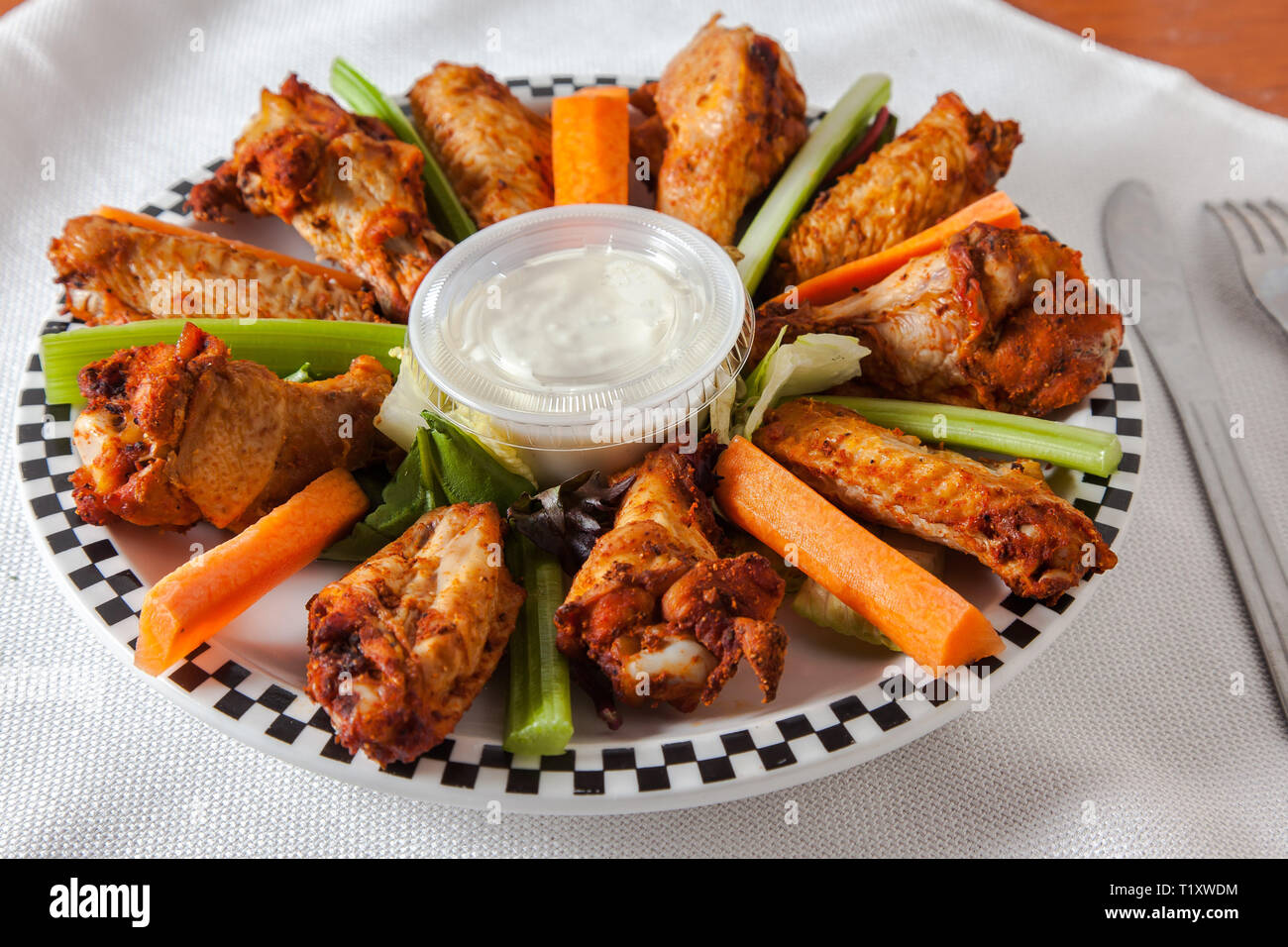 Buffalo wings on plate ready to eat Stock Photo - Alamy