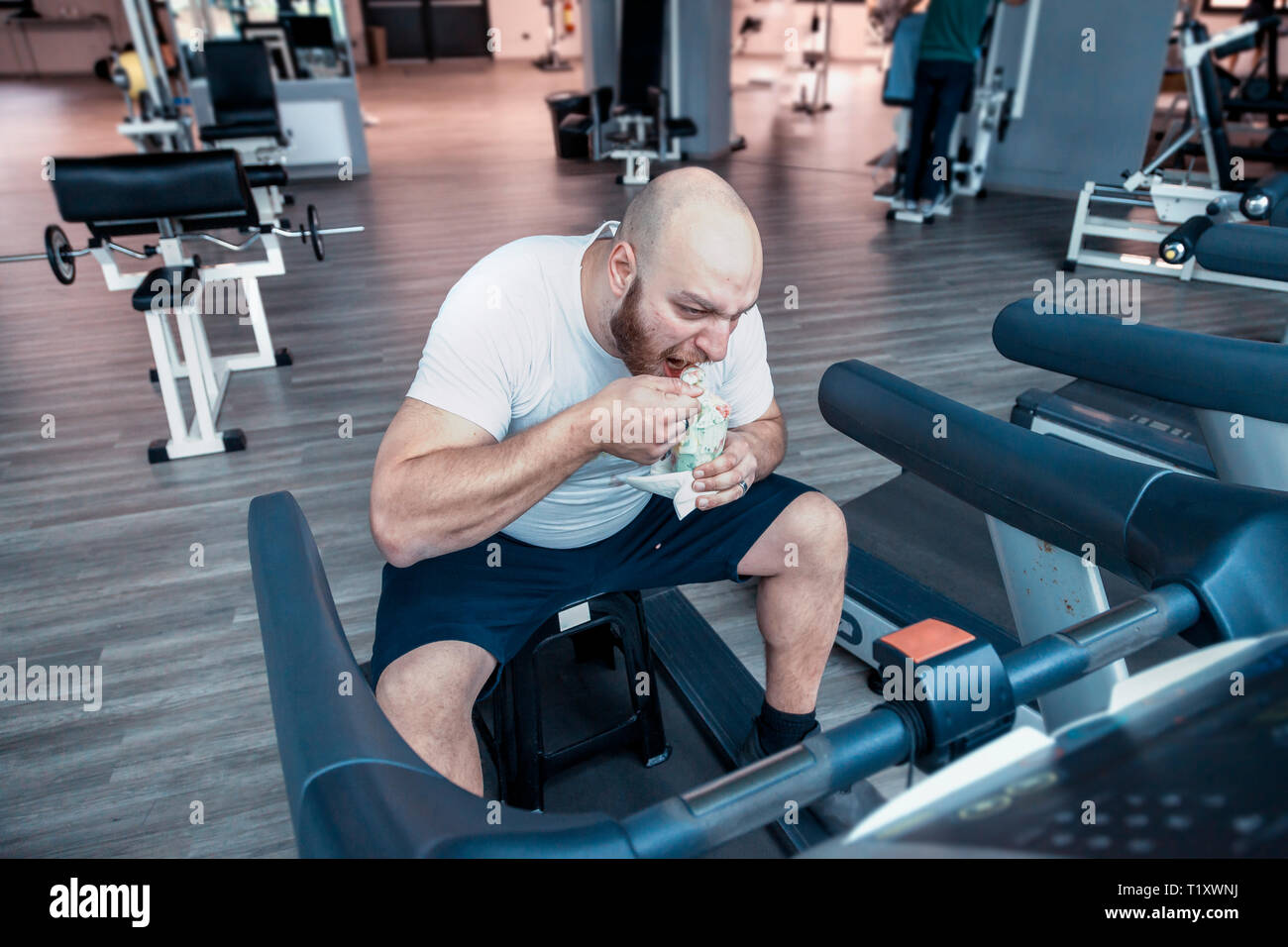 runner athlete while relaxing eating an ice cream on the driving ...