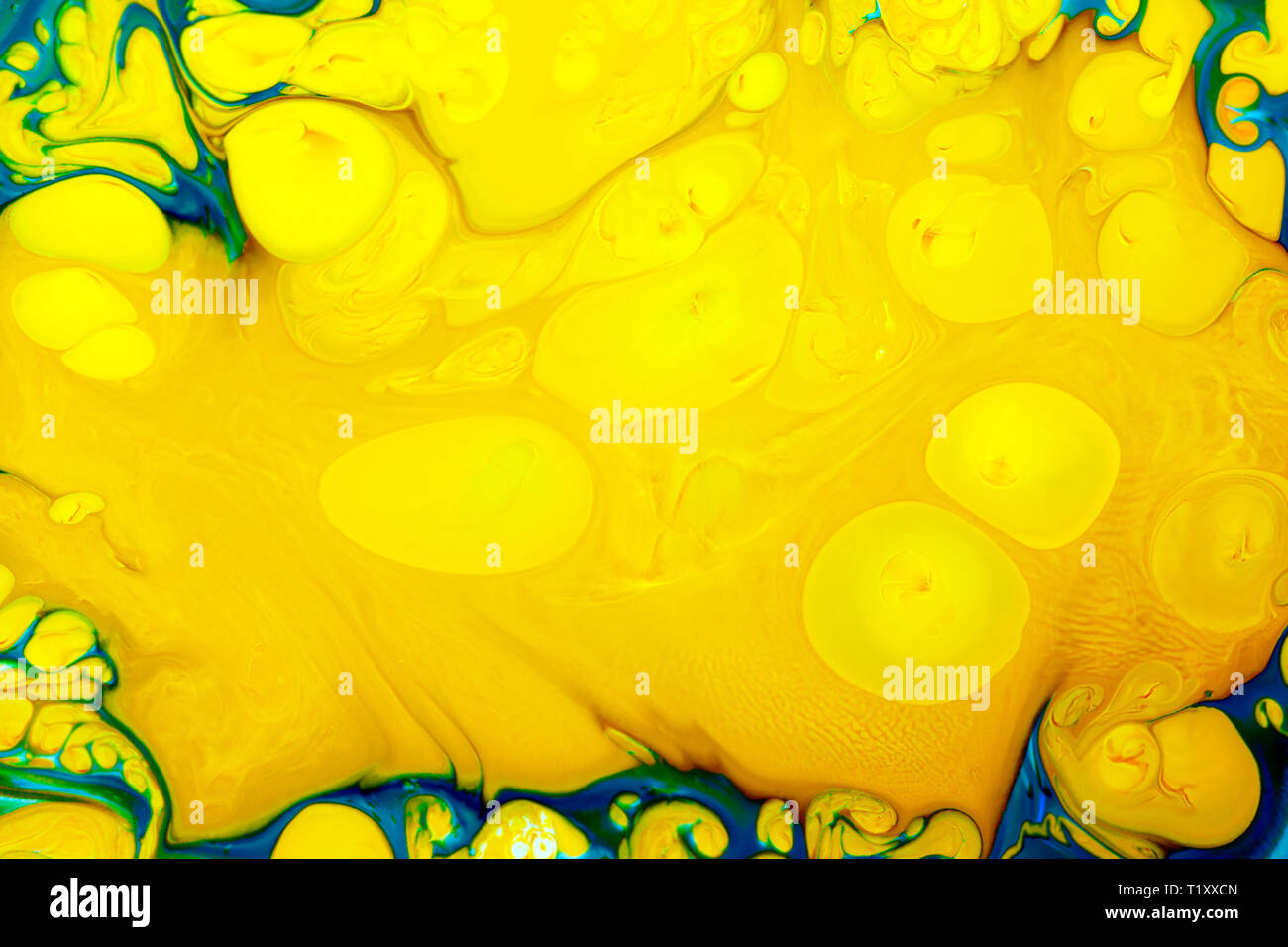 Abstract colored yellow and blue acrylic paints. View of macro world ...