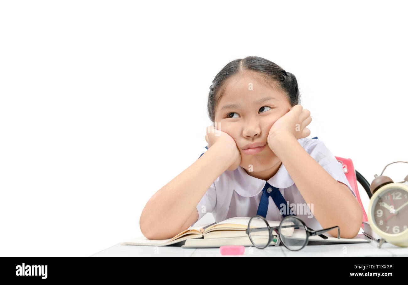 Bored and tired asian student girl doing homework isolated on white ...