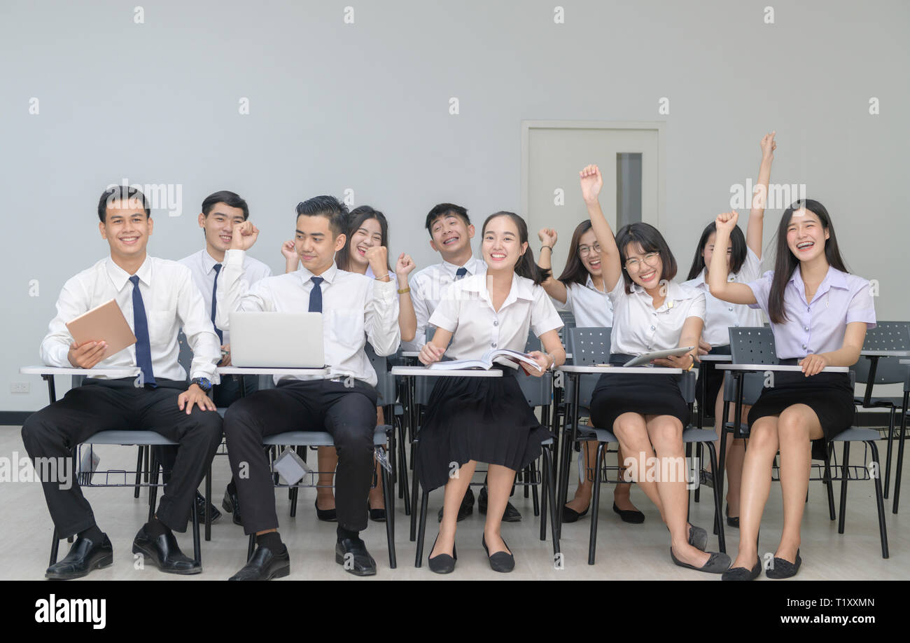 Happy Students in uniform working with laptop in classroom at ...