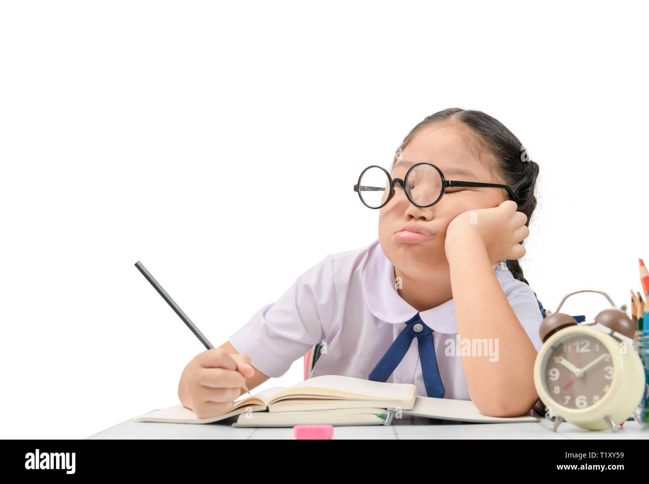 Bored and tired asian student girl doing homework isolated on white ...